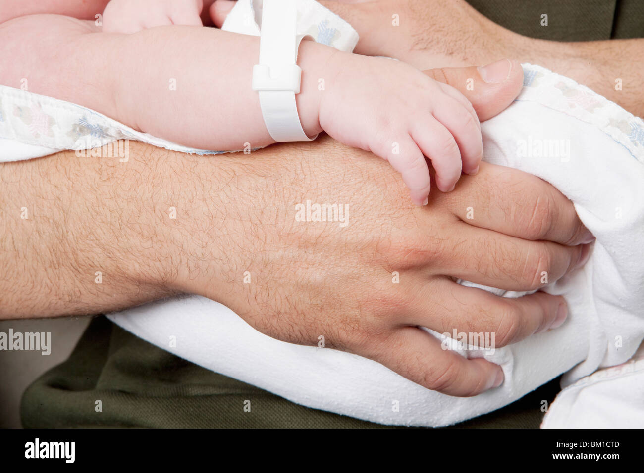 Man carrying his newborn baby Stock Photo - Alamy