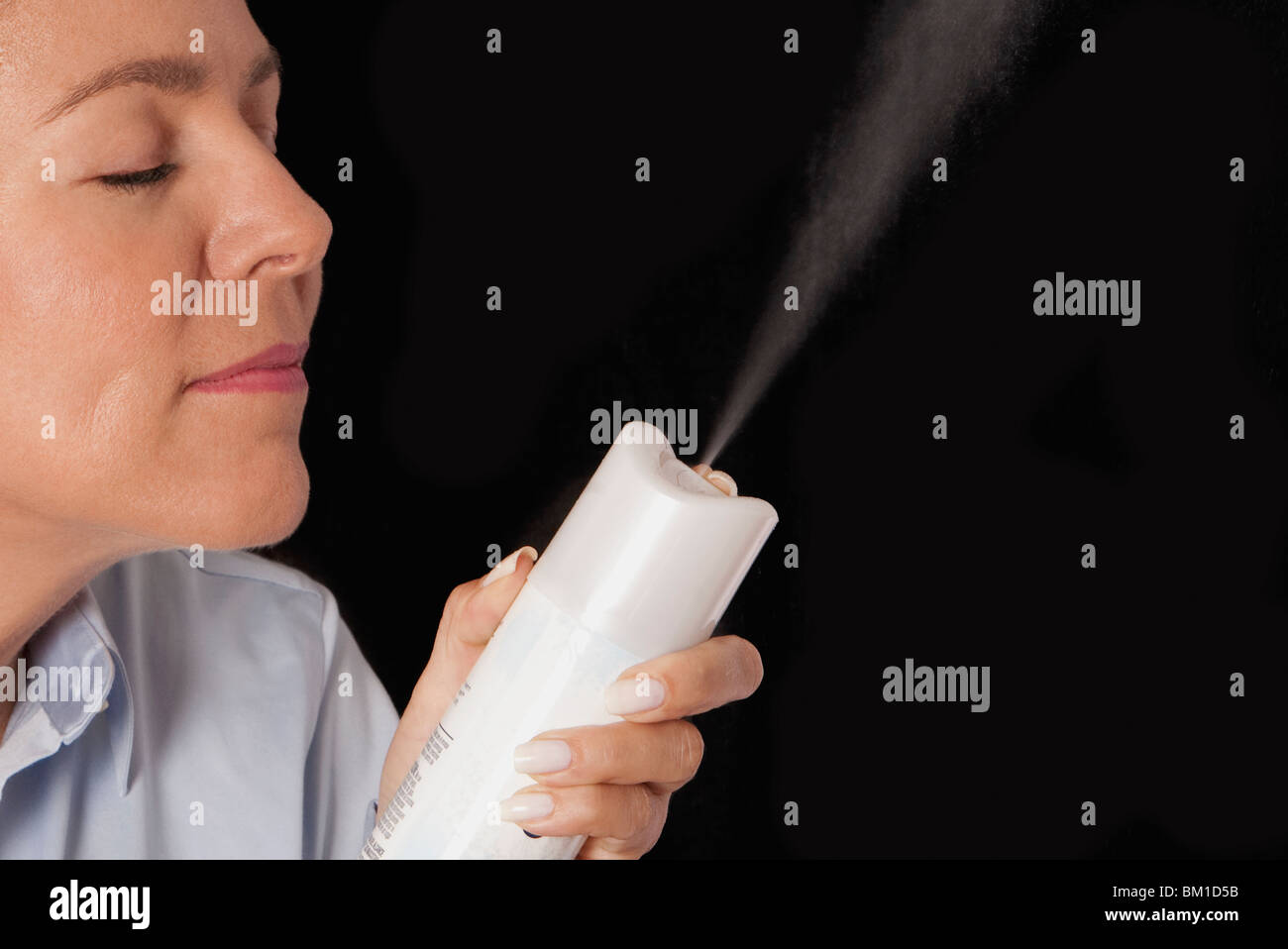 Mature woman spraying perfume hi-res stock photography and images - Alamy