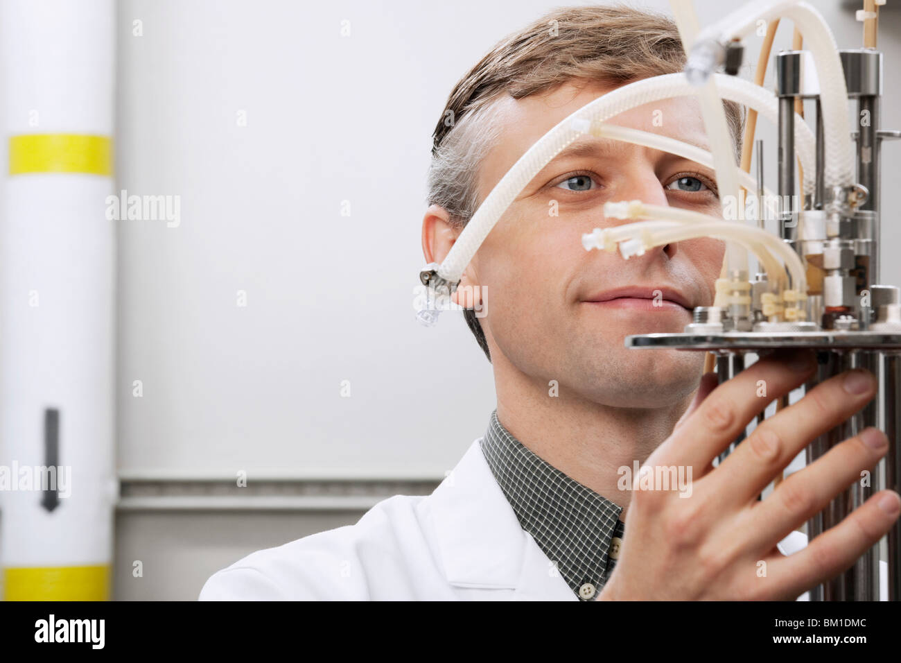 Scientist working on a bioreactor headplate with mixer assembly and ...