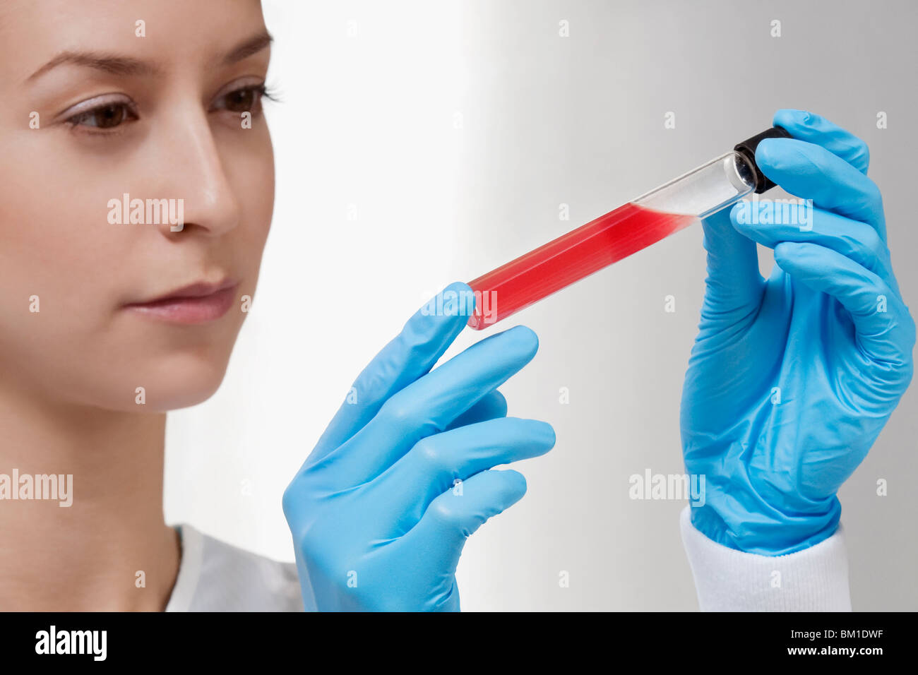 Female doctor holding a medical sample in a laboratory Stock Photo - Alamy