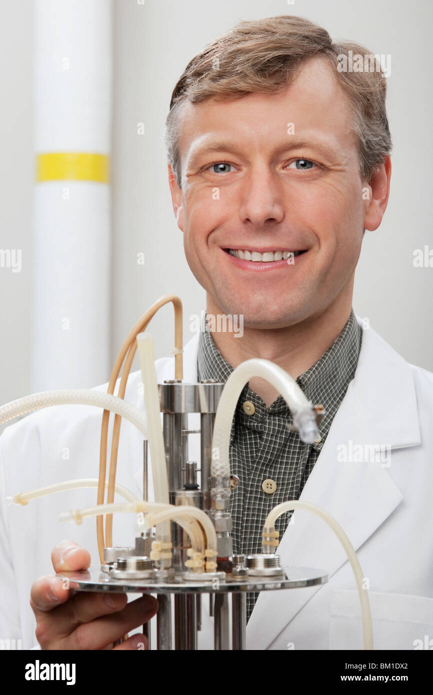 Scientist working on a bioreactor headplate with mixer assembly and ...