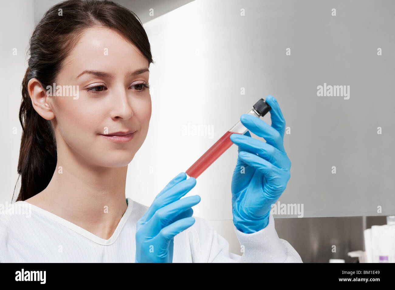 Female doctor holding a medical sample in a laboratory Stock Photo - Alamy