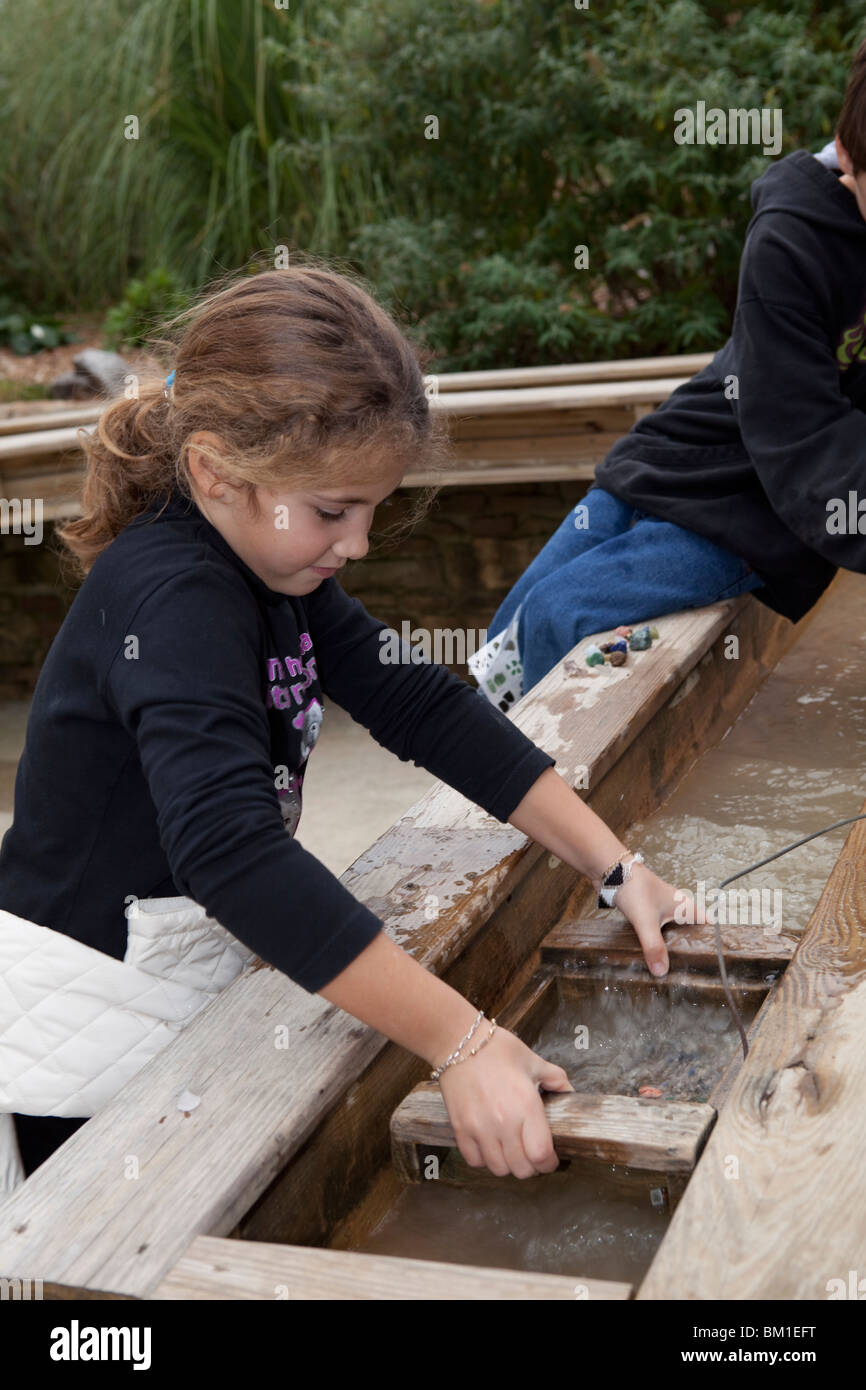 Little girl washing the sand searching for gems Stock Photo - Alamy