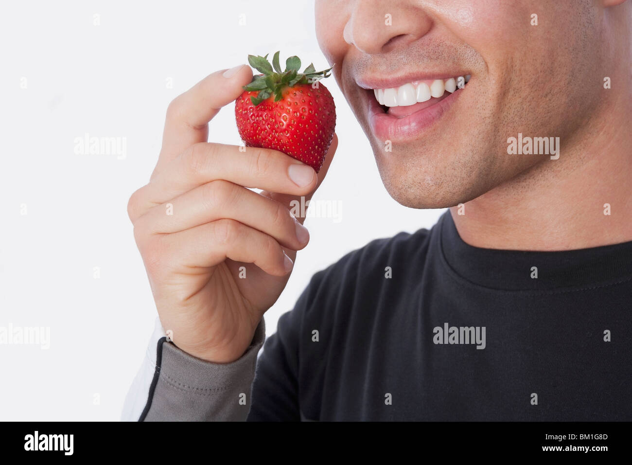 Man holding a strawberry Stock Photo - Alamy