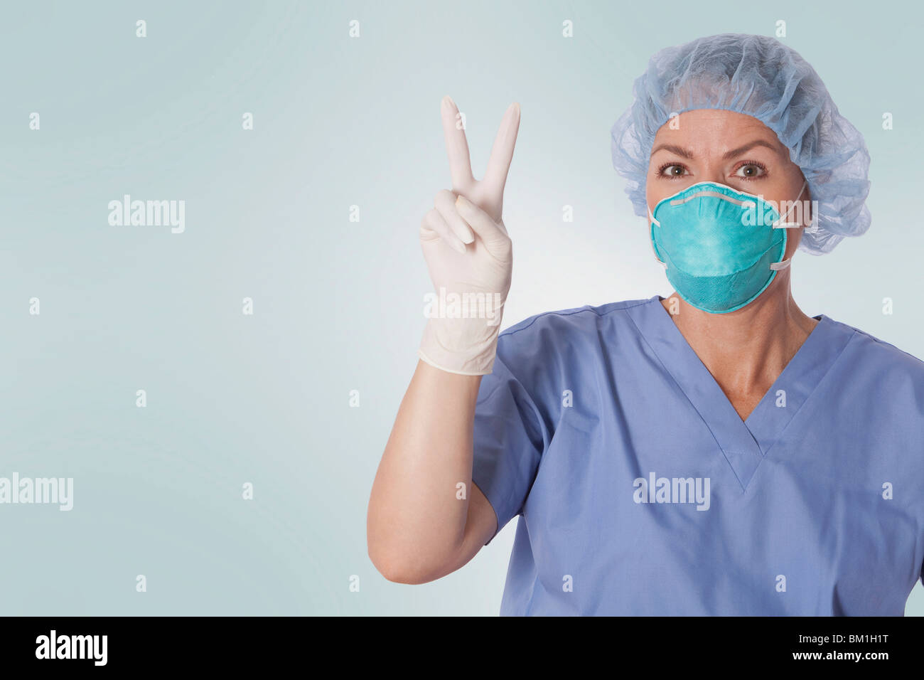 Female surgeon showing victory sign Stock Photo - Alamy