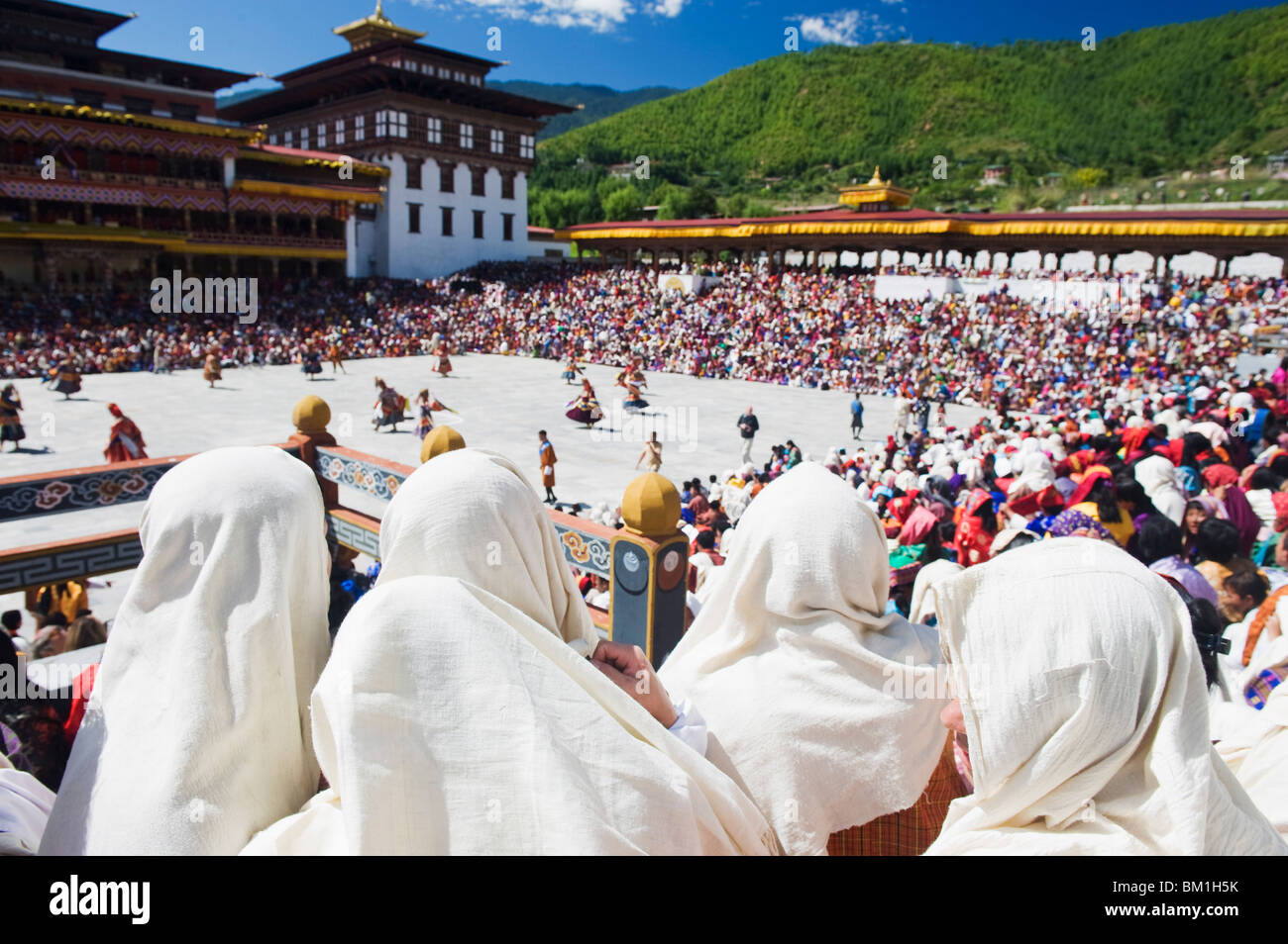 Spectators watching the Autumn Tsechu (festival) at Trashi Chhoe Dzong ...