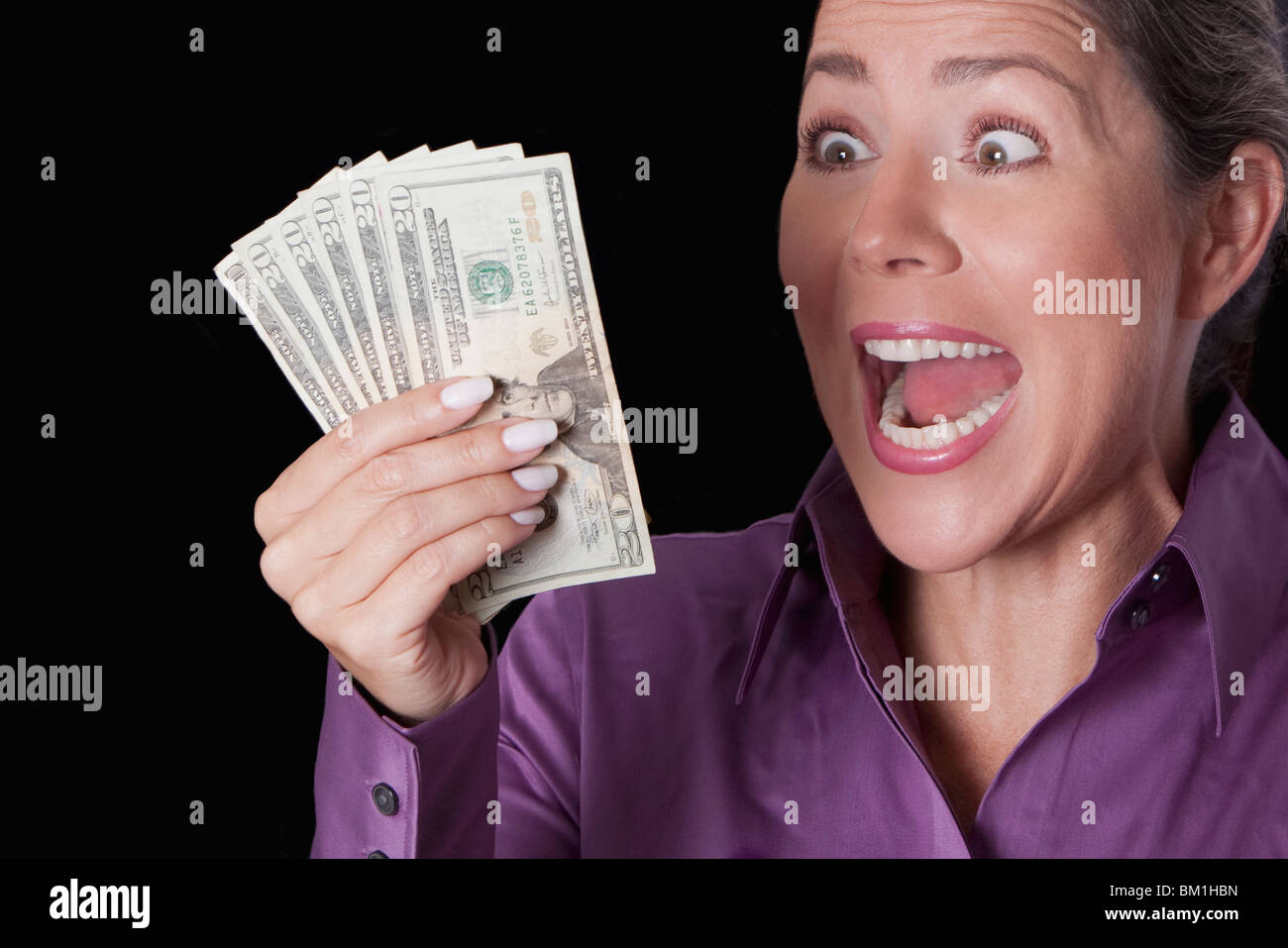 Woman holding currency notes and shouting Stock Photo - Alamy