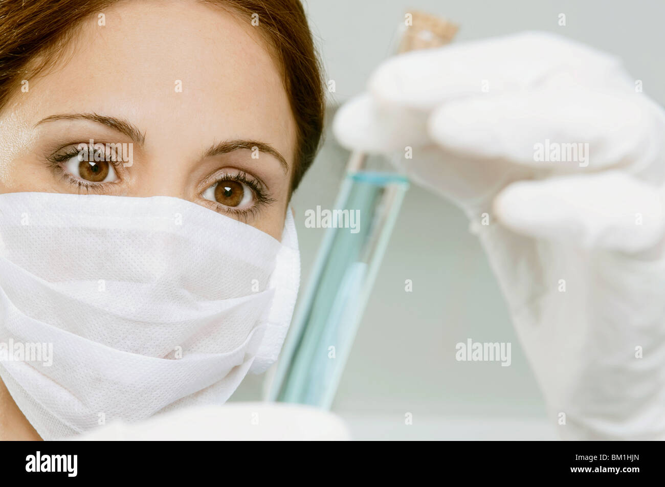 Female lab technician analyzing sample in test tube Stock Photo - Alamy