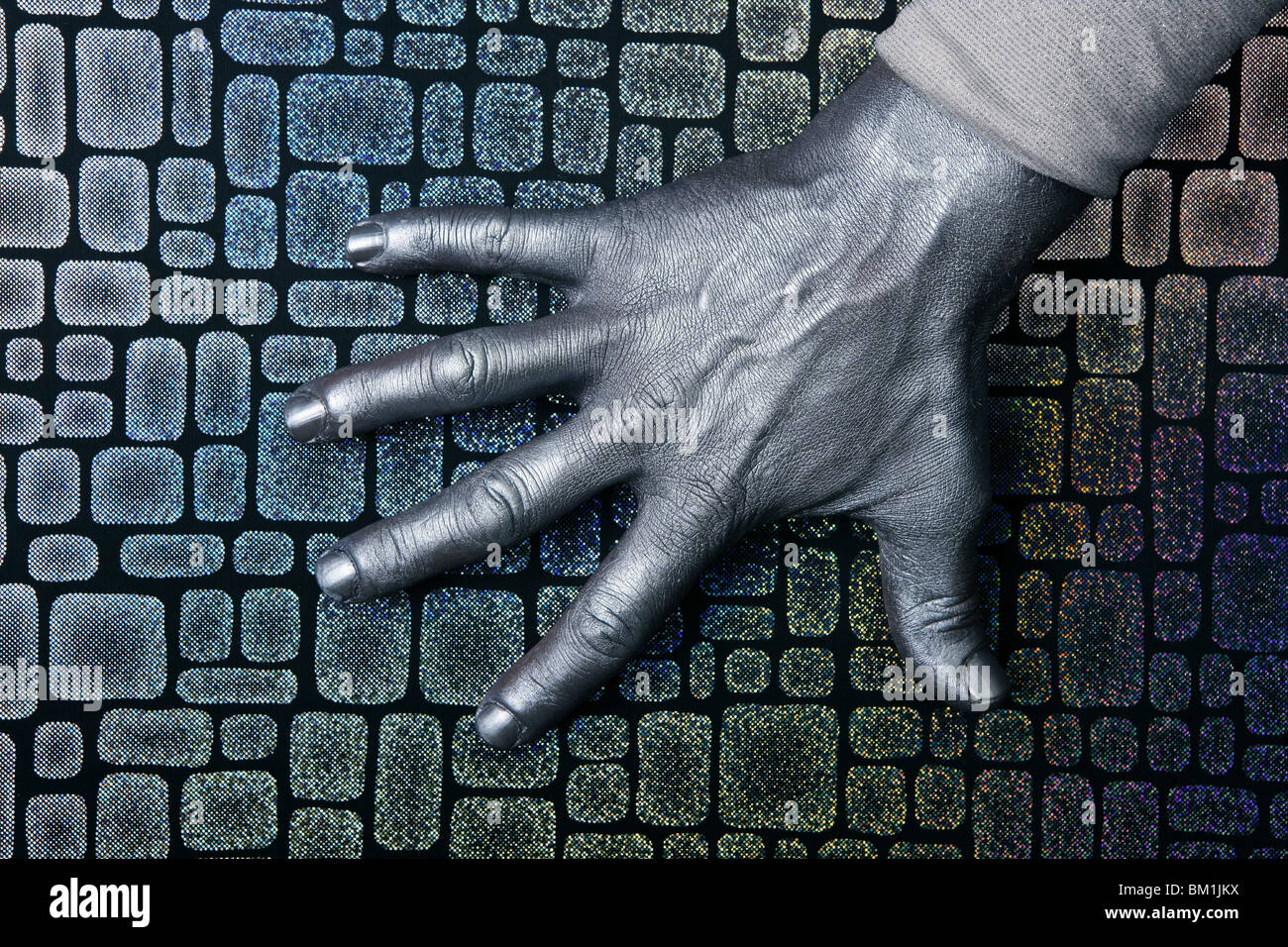 male futuristic man silver hand over textured steel background Stock ...