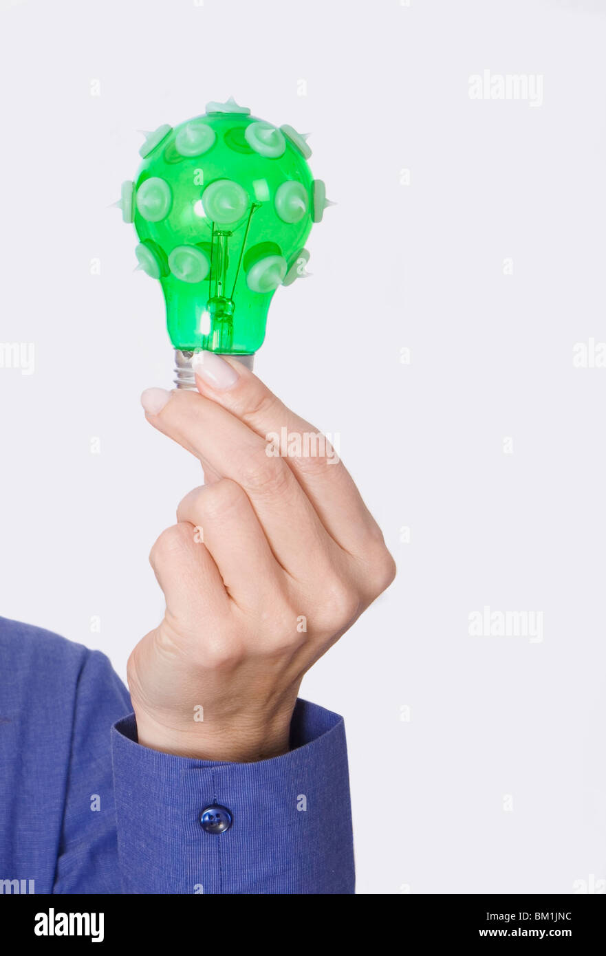 Person's hand holding green light bulb Stock Photo - Alamy