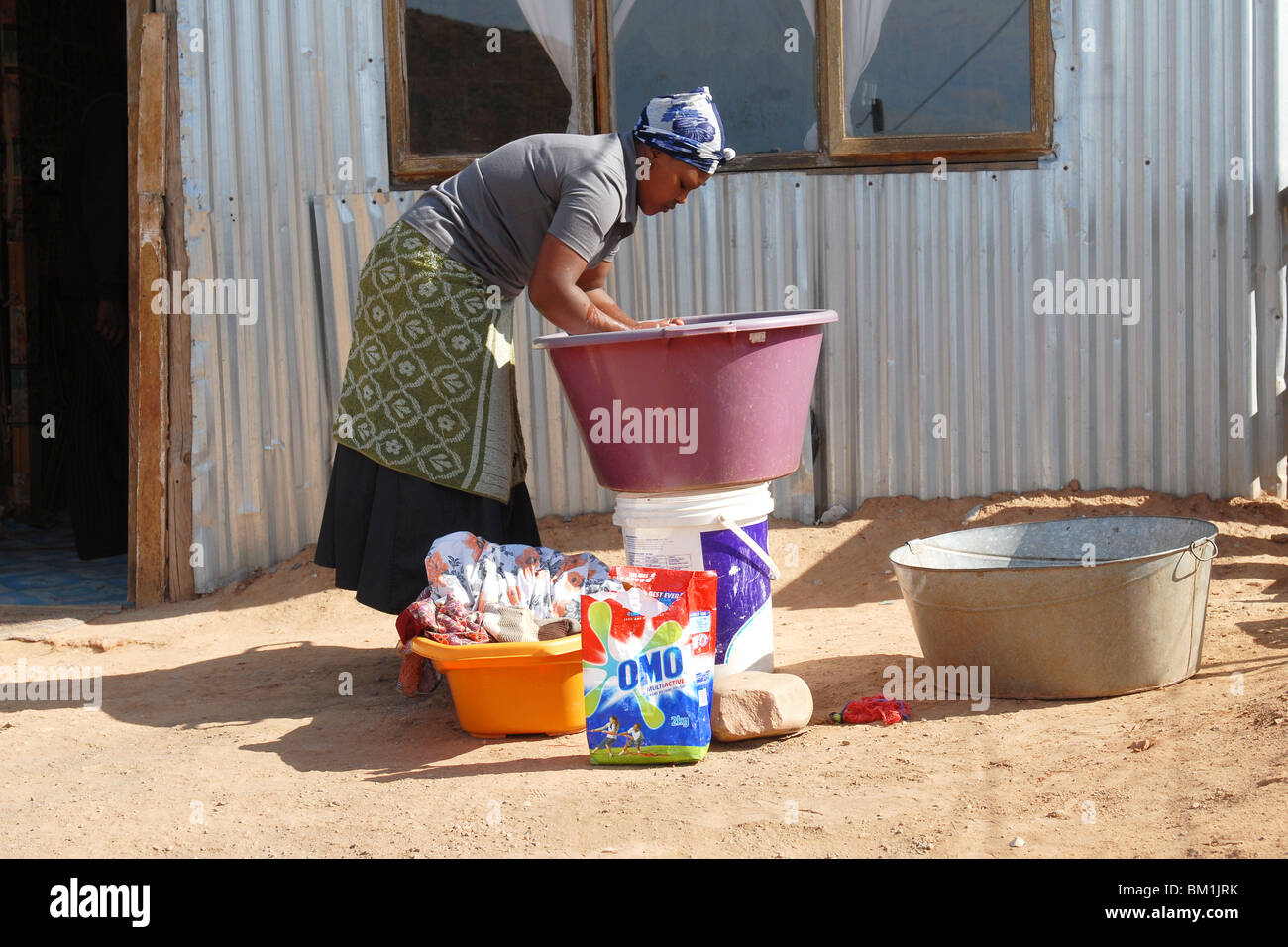 washing in front of her shack Stock Photo - Alamy