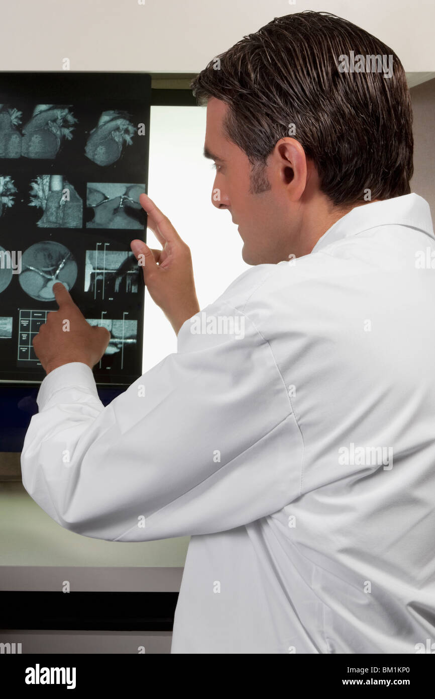Doctor examining MRI report Stock Photo - Alamy