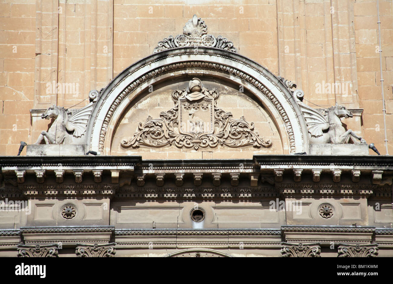 A decorative cartouche shaped in a semi circle bordered by two winged ...