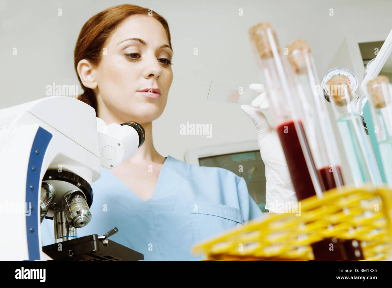 Medical worker in front microscope hi-res stock photography and images ...