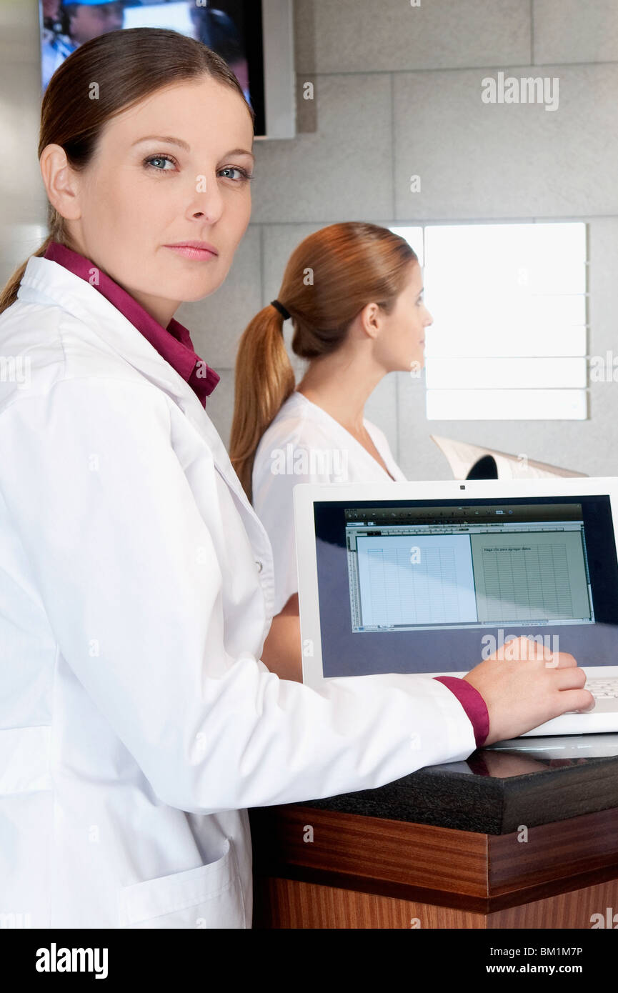 Female doctor working on a laptop Stock Photo - Alamy