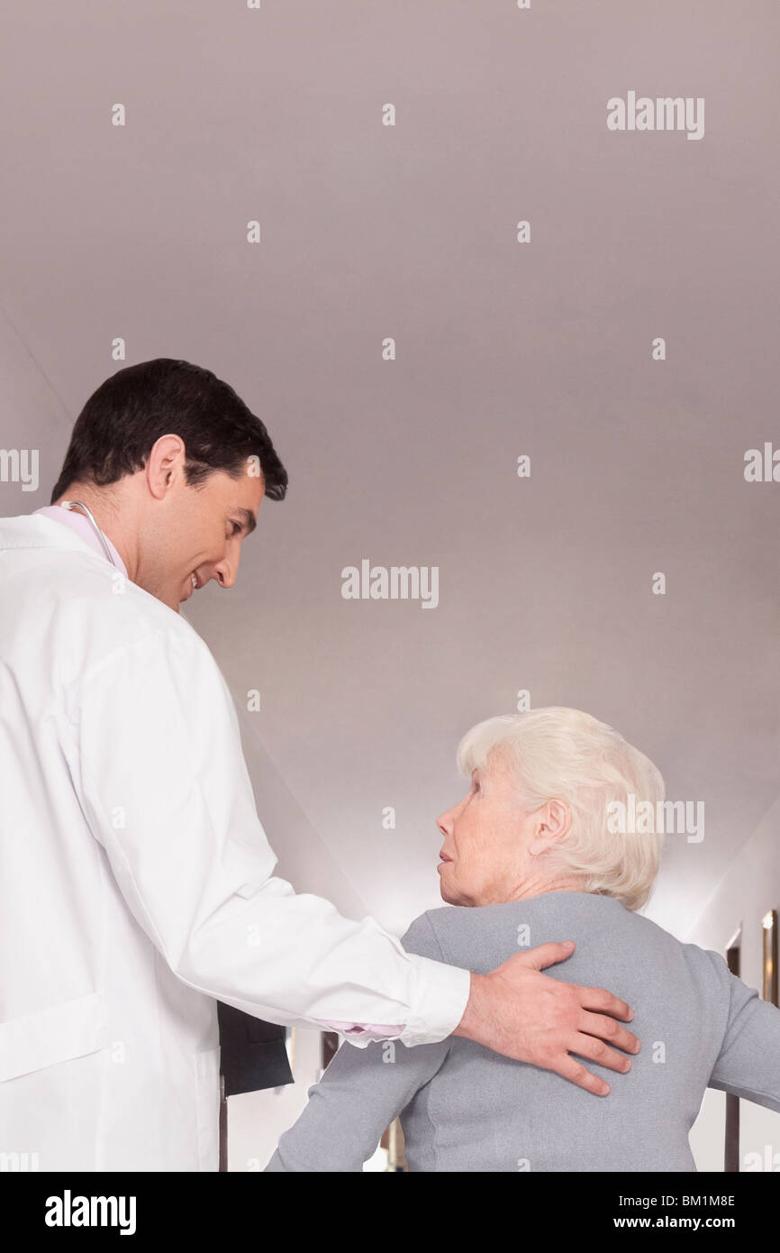 Doctor advising a woman Stock Photo - Alamy