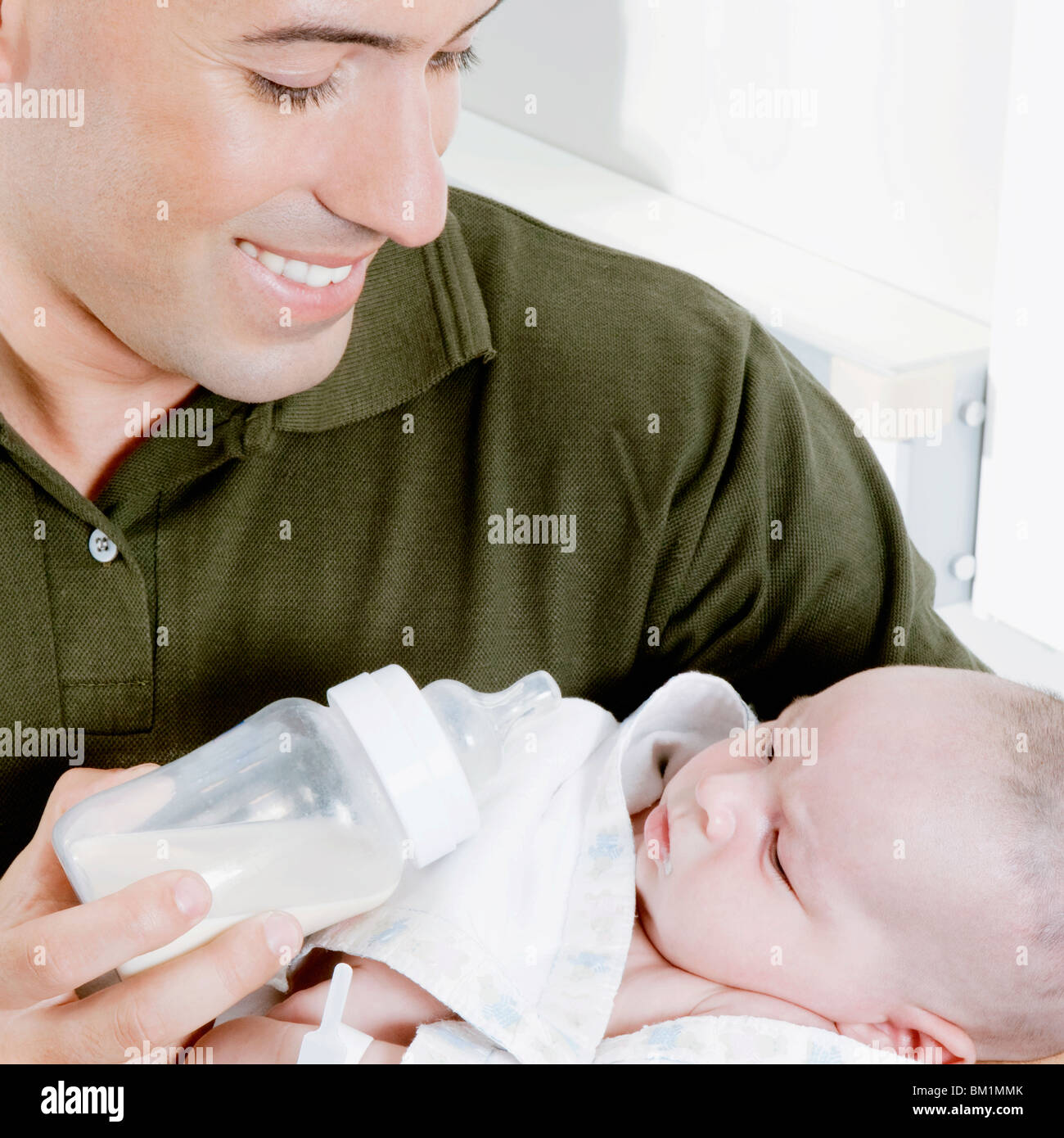 Man carrying his newborn baby Stock Photo - Alamy