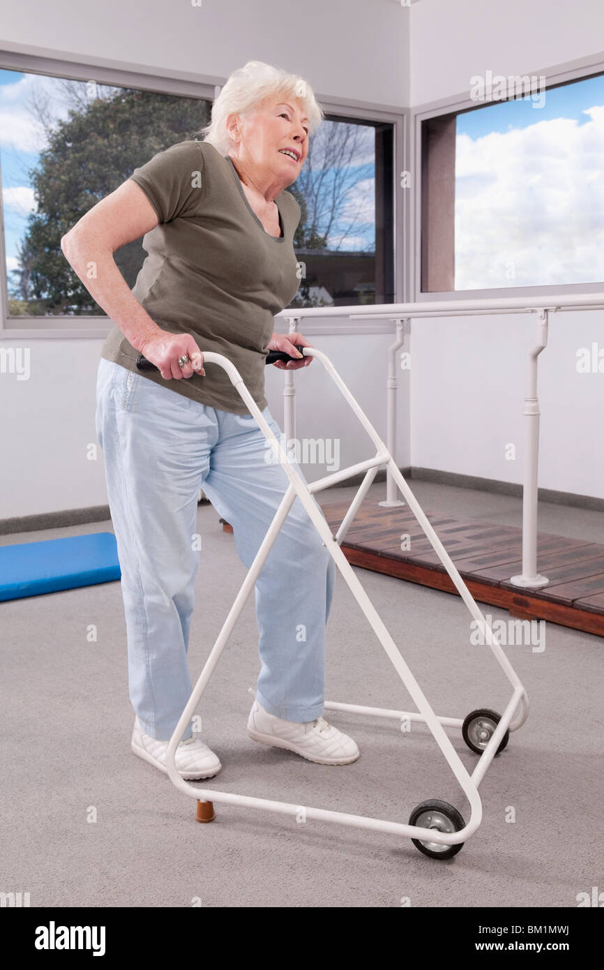 Disabled woman walking with the help of walker Stock Photo - Alamy