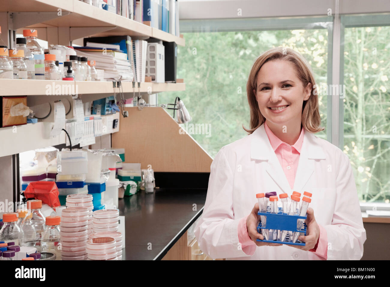Female doctor holding medical samples in a laboratory Stock Photo - Alamy