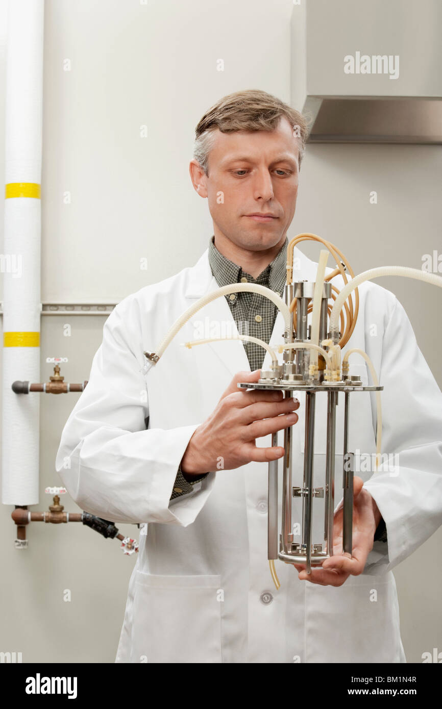 Scientist working on a bioreactor headplate with mixer assembly and ...