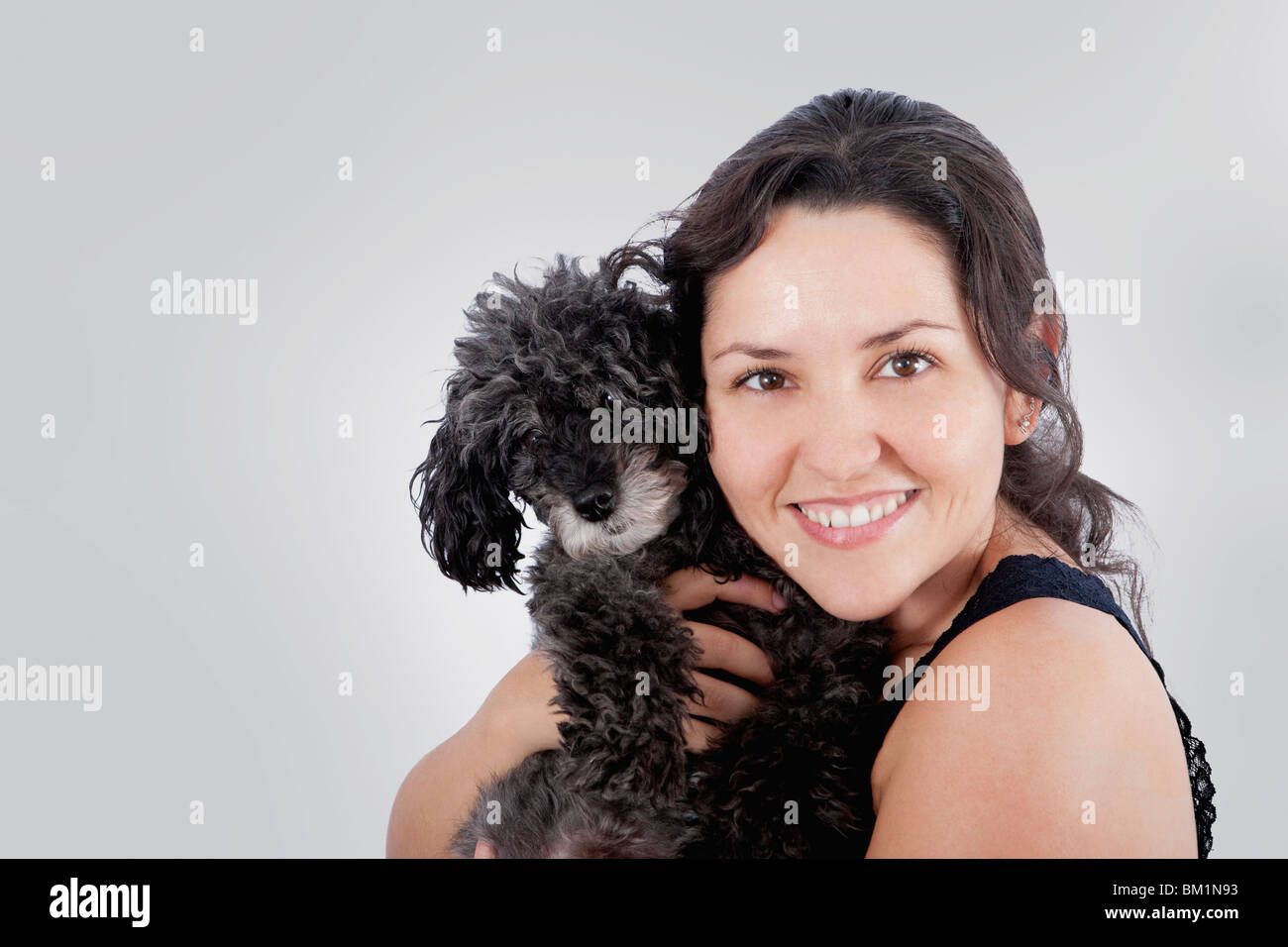 Portrait of a woman hugging a Poodle Stock Photo - Alamy