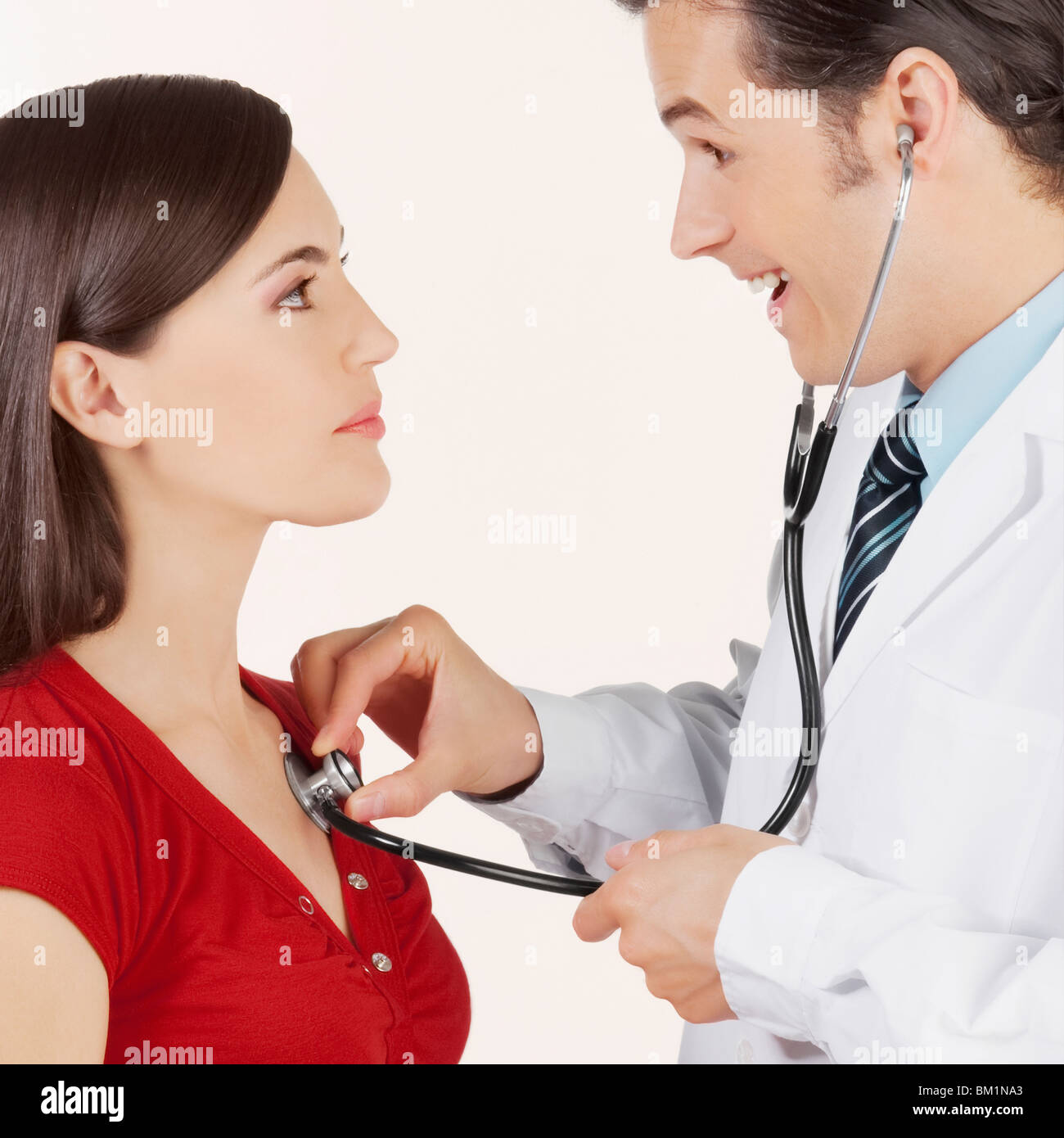 Doctor examining a woman with a stethoscope Stock Photo - Alamy