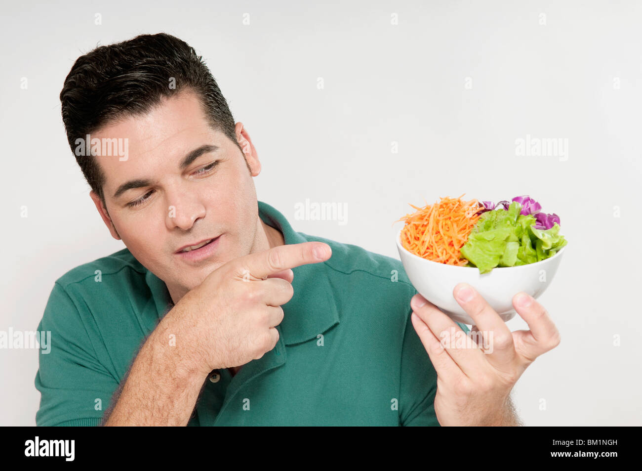 Man pointing at a salad bowl Stock Photo - Alamy