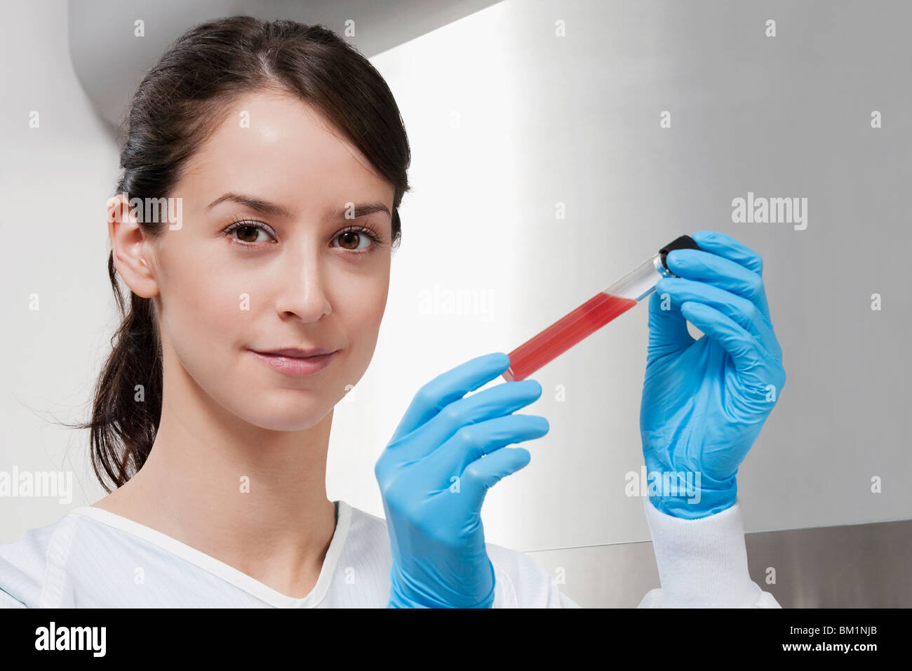 Female doctor holding a medical sample in a laboratory Stock Photo - Alamy