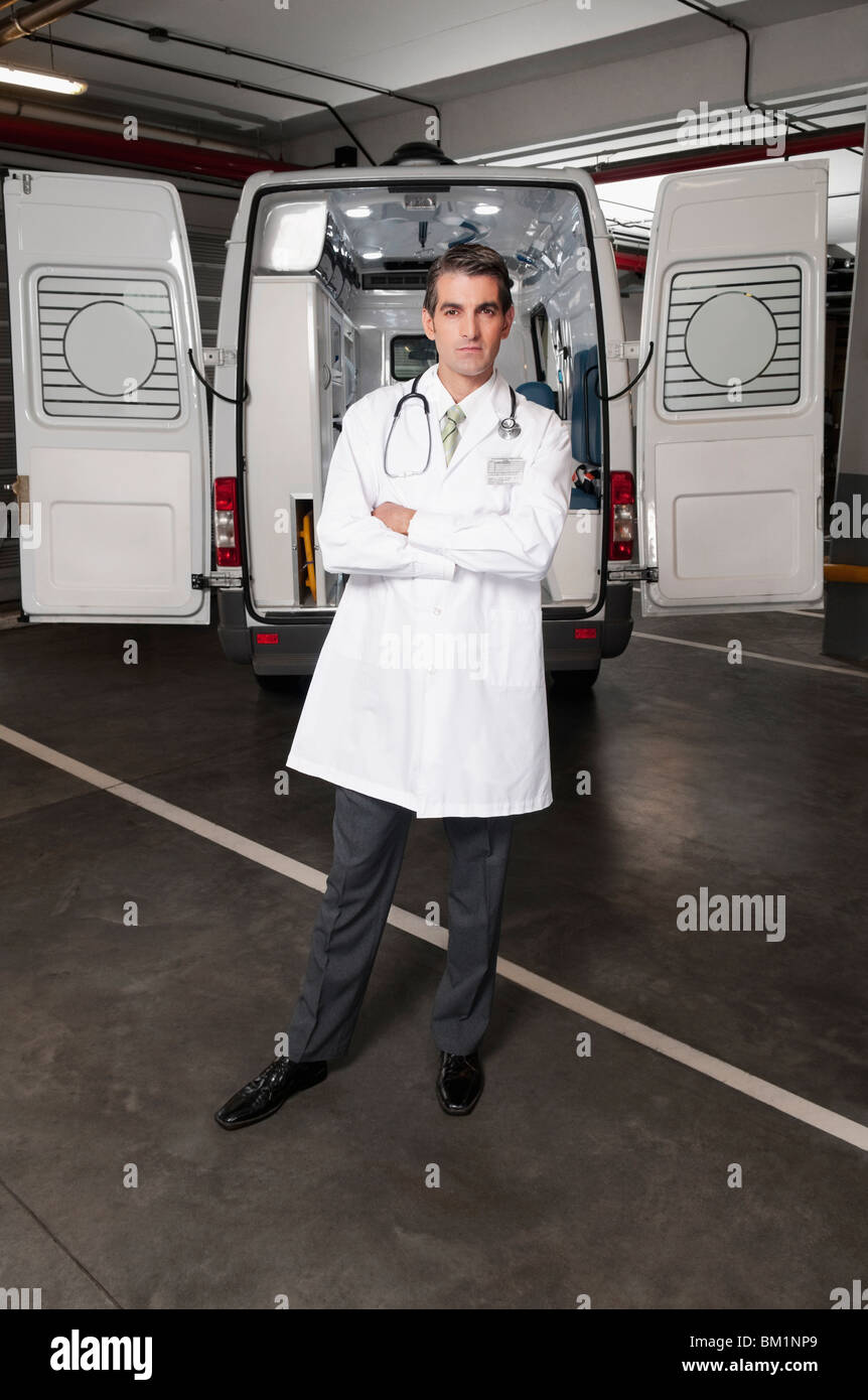 Doctor standing with an ambulance behind him Stock Photo - Alamy