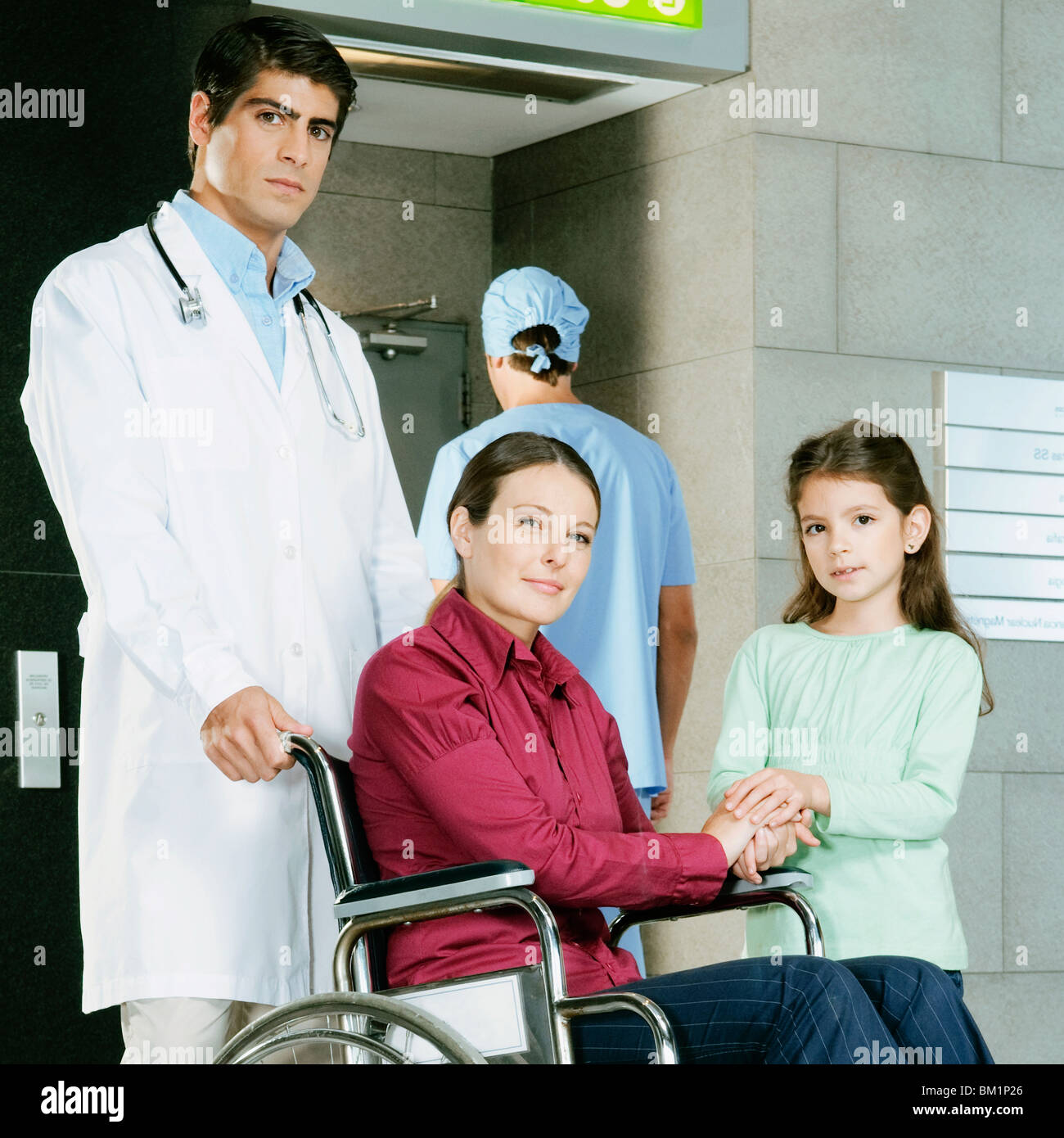 Doctor pushing a woman in a wheelchair Stock Photo - Alamy