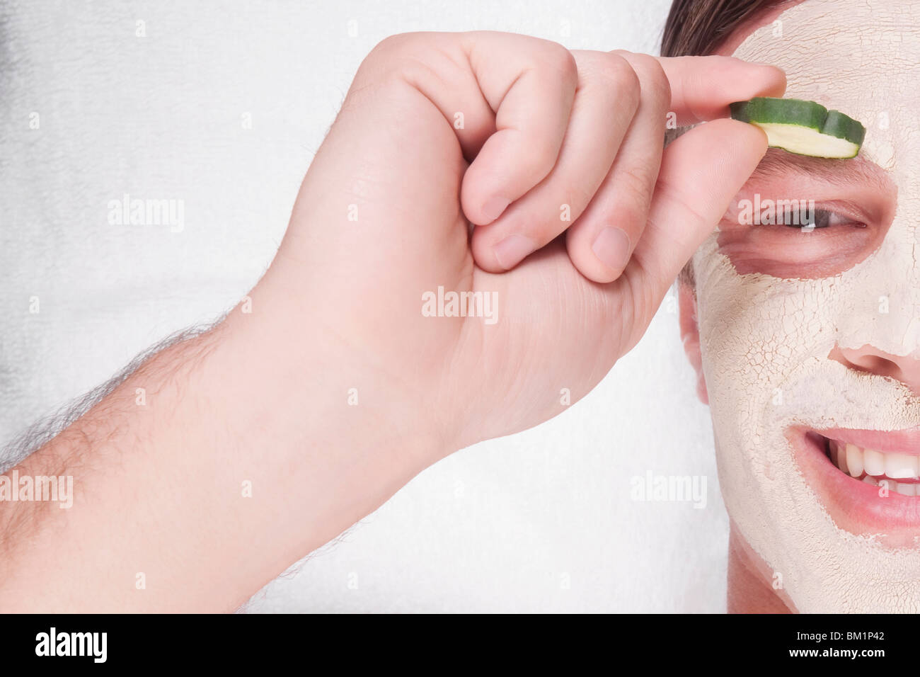 Cucumber slice on a man's eye Stock Photo - Alamy