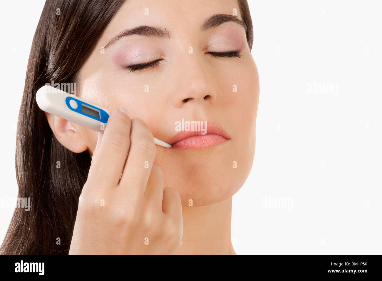 Woman taking her temperature Stock Photo - Alamy