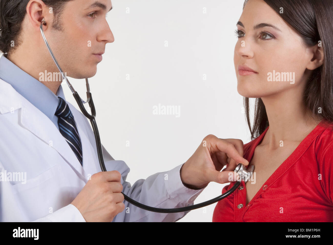 Doctor examining a woman Stock Photo - Alamy