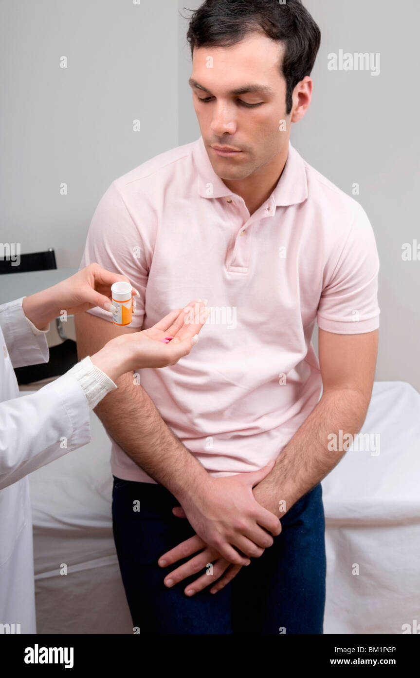 Doctor giving medicine to a patient Stock Photo - Alamy