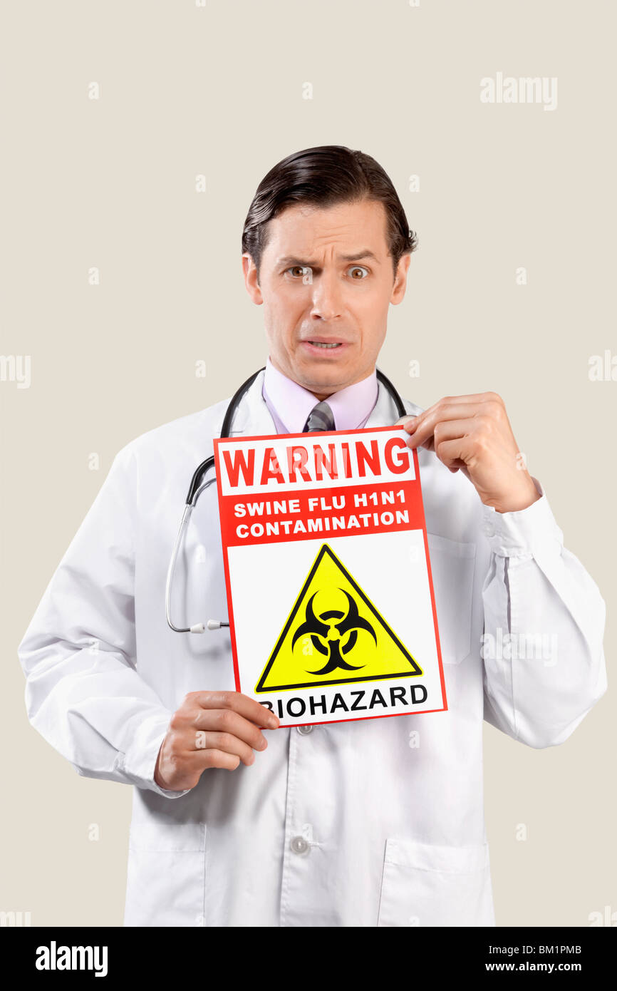 Portrait of a doctor showing a Biohazard warning sign Stock Photo - Alamy