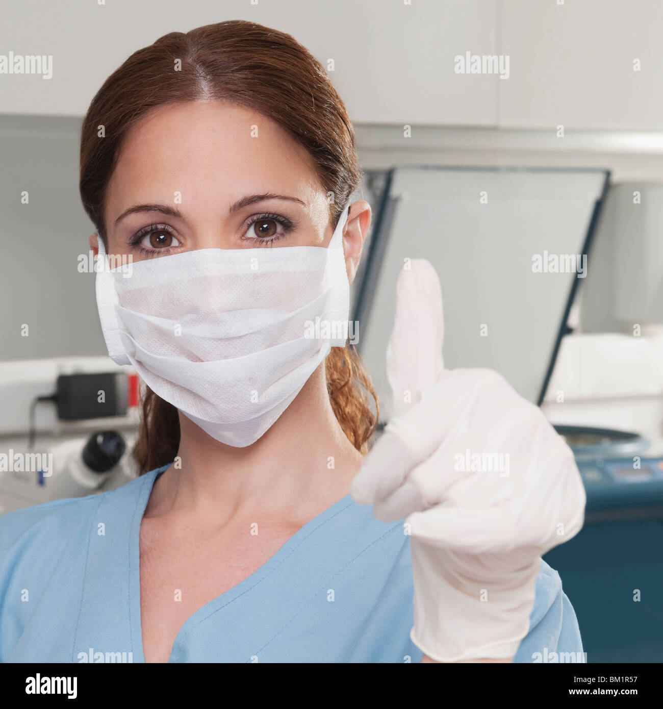 Female lab technician showing thumbs up sign in a laboratory Stock ...