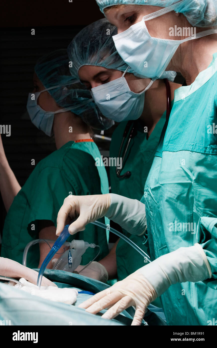 Surgeons performing a surgery in an operating room Stock Photo - Alamy