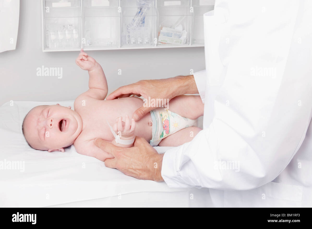 Doctor examining a newborn baby Stock Photo - Alamy