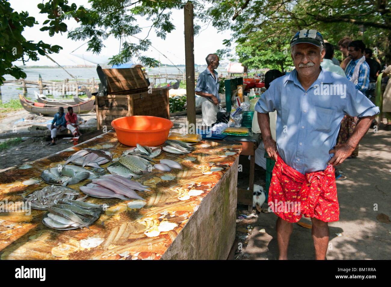 A Fishmonger on his stall near the Chinese Fishing Nets in Cochin ...