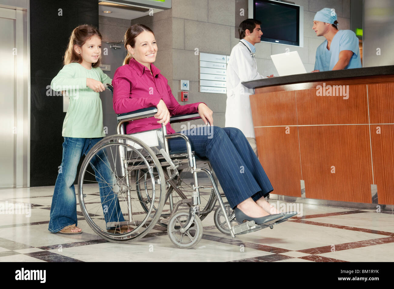 Girl pushing her mother in a wheelchair Stock Photo - Alamy