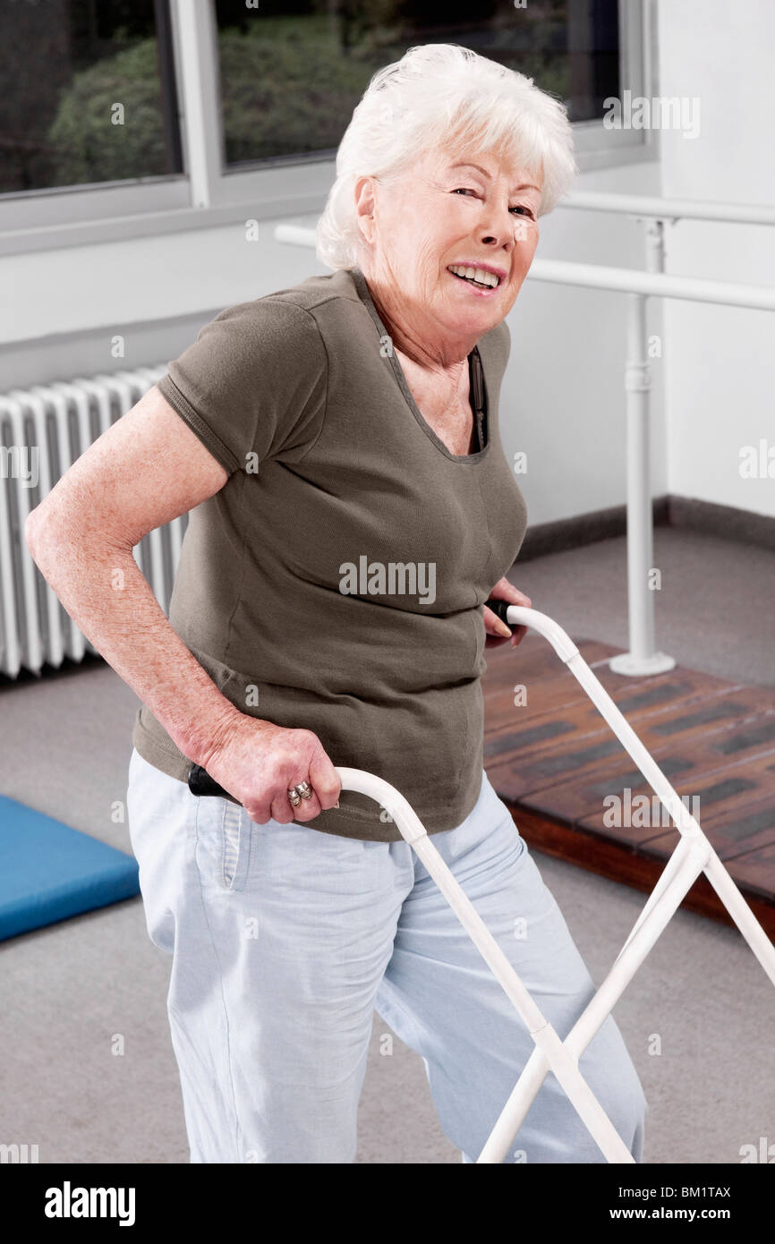 Disabled woman walking with a walker Stock Photo - Alamy