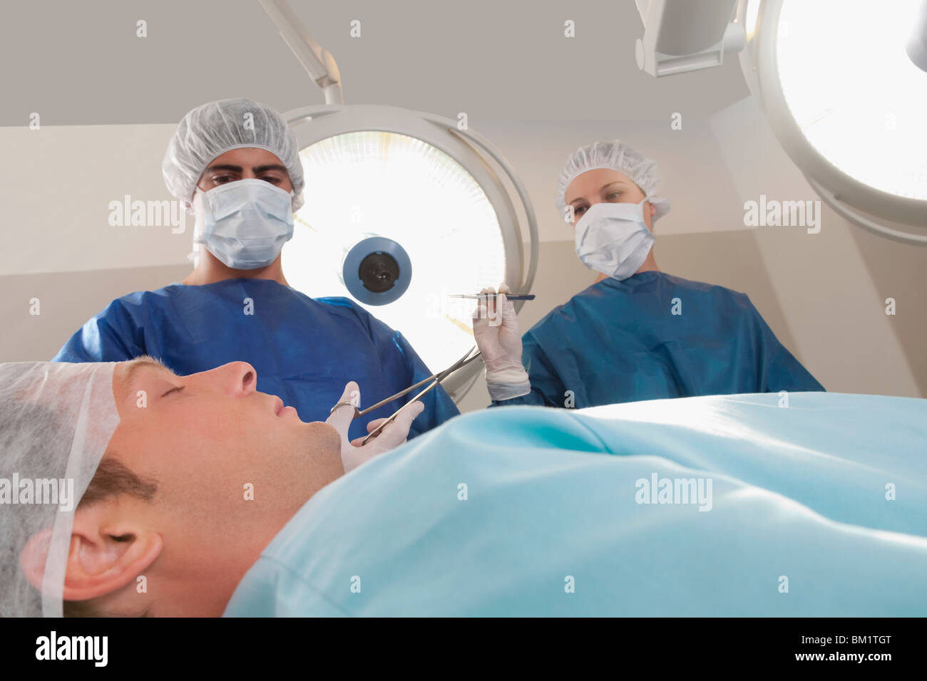Two surgeons operating a patient in an operating room Stock Photo - Alamy