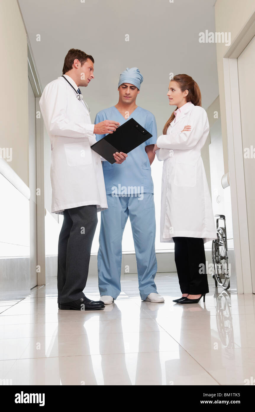 Three doctors discussing in a hospital Stock Photo - Alamy