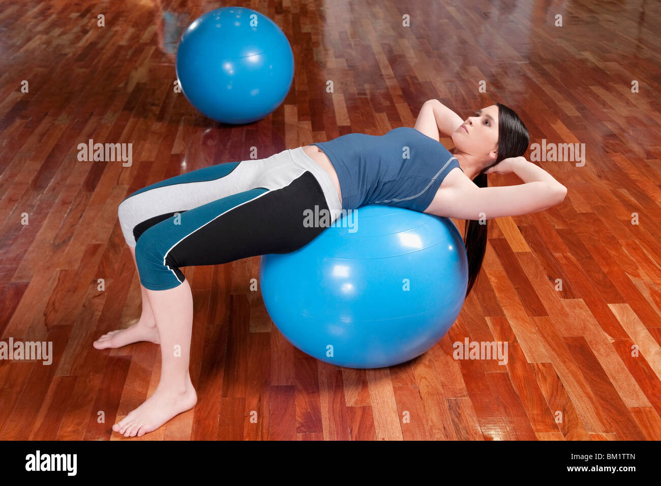 Woman doing sit ups on a fitness ball hi-res stock photography and ...