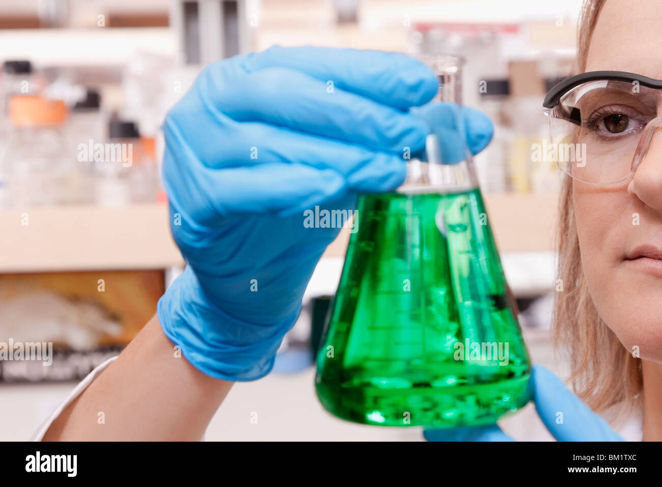 Female doctor holding a conical flask in a laboratory Stock Photo - Alamy
