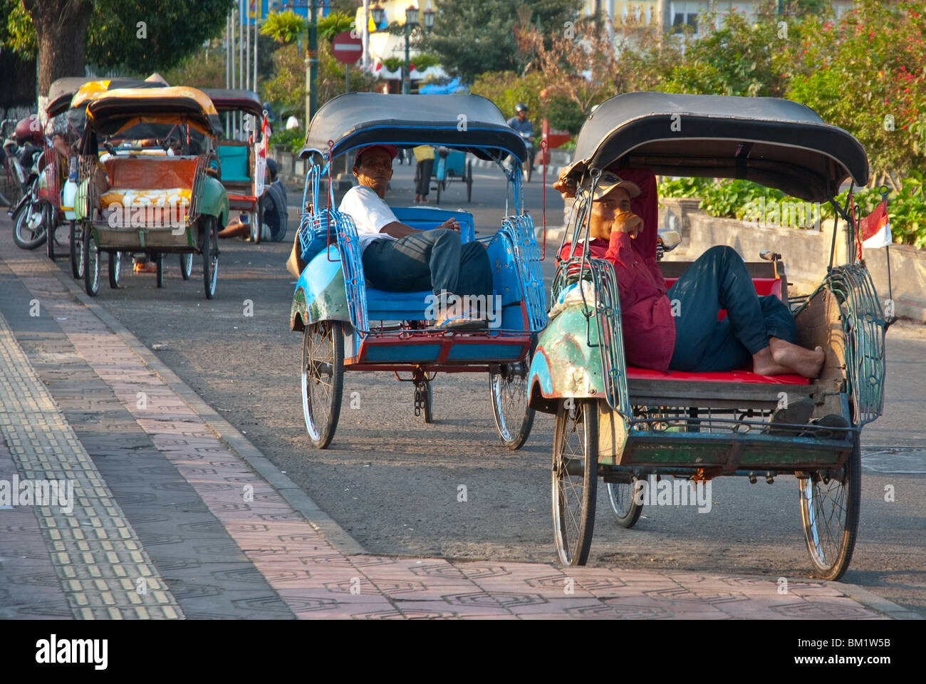 Rickshaw drivers waiting to pick up customers in Jogyakarta, Java ...