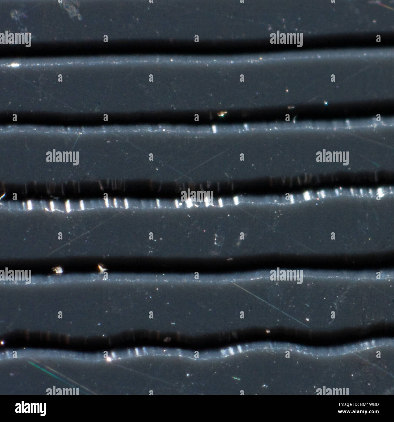 Extreme close-up of the tracks in a vinyl LP record. All sides of the ...