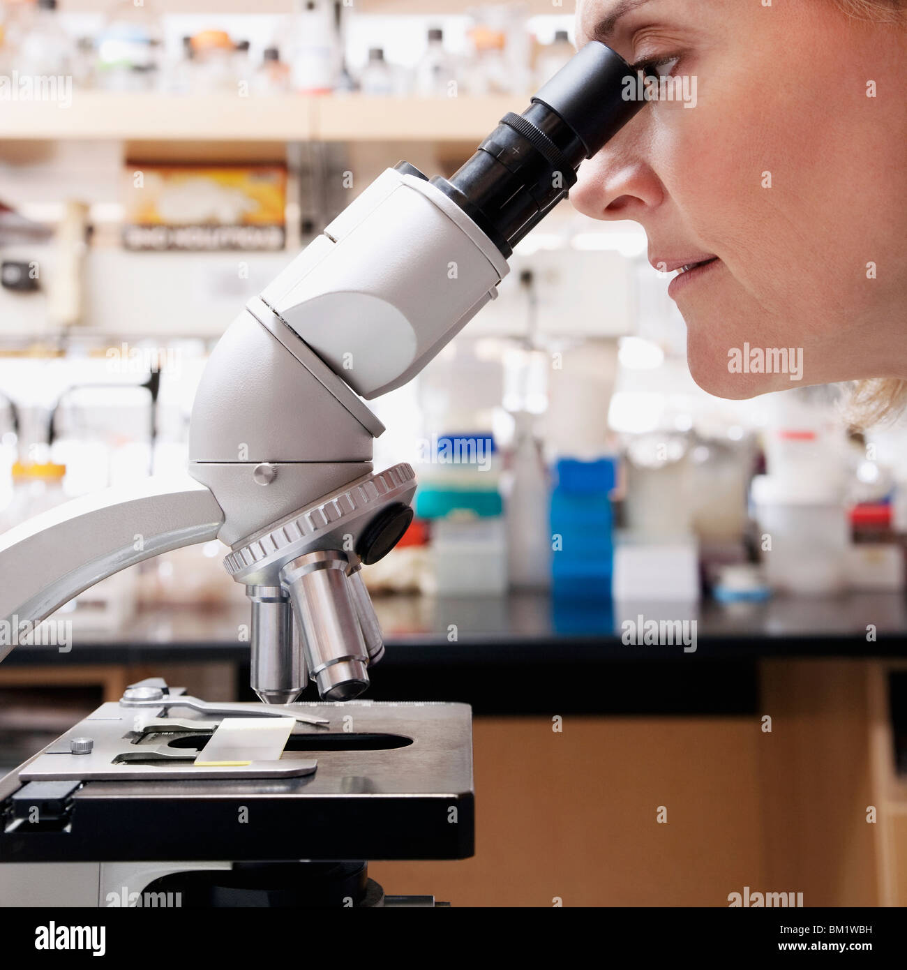 Female doctor working on a microscope in a laboratory Stock Photo - Alamy