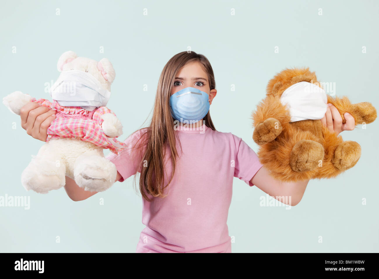 Girl wearing a flu mask and holding stuffed toys Stock Photo - Alamy