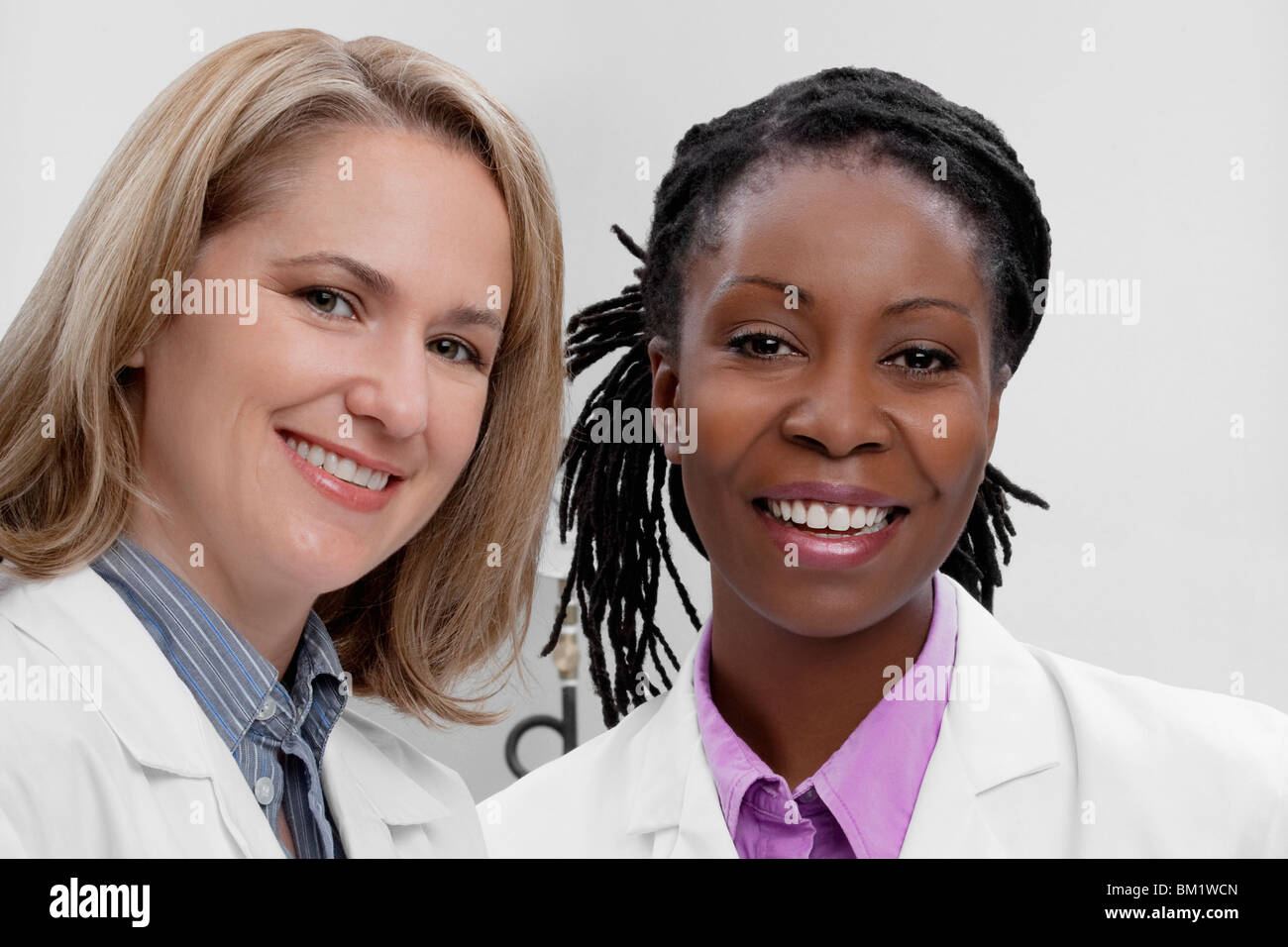 Portrait of two female doctors smiling Stock Photo - Alamy